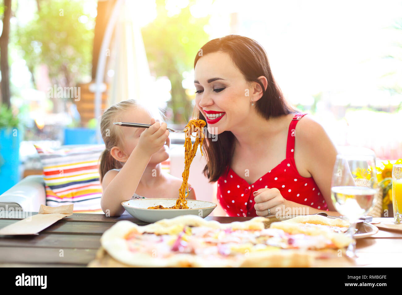 Happy family eating spaghetti hi-res stock photography and images - Alamy