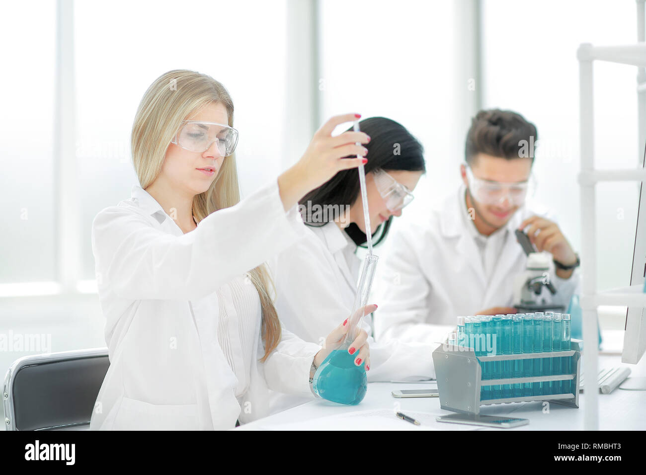 close up.a team of scientists conduct fluid research Stock Photo - Alamy