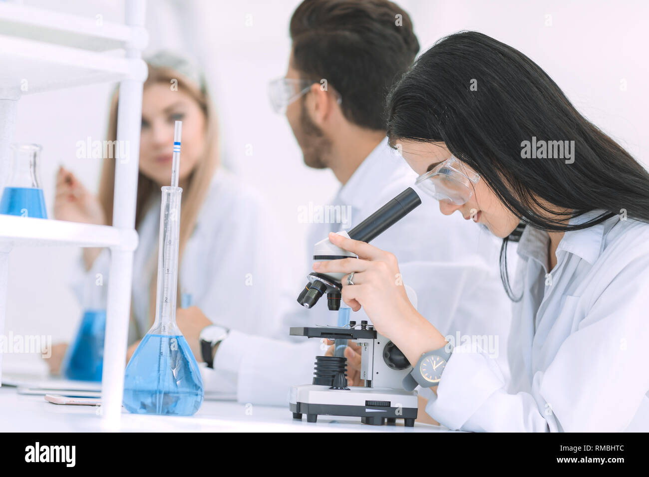 female scientist uses a microscope in the laboratory Stock Photo - Alamy
