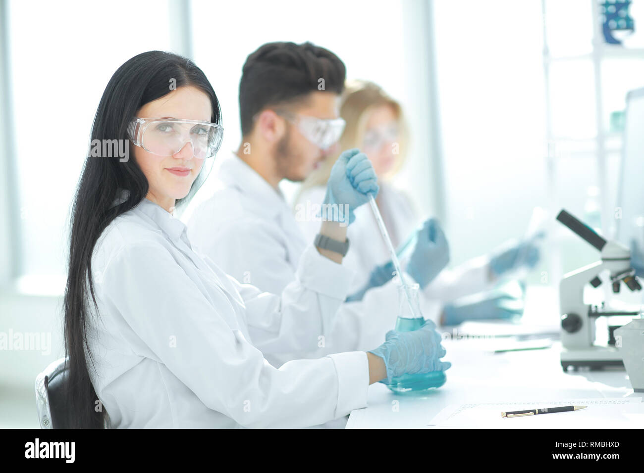 Closeup woman looking through microscope hi-res stock photography and ...