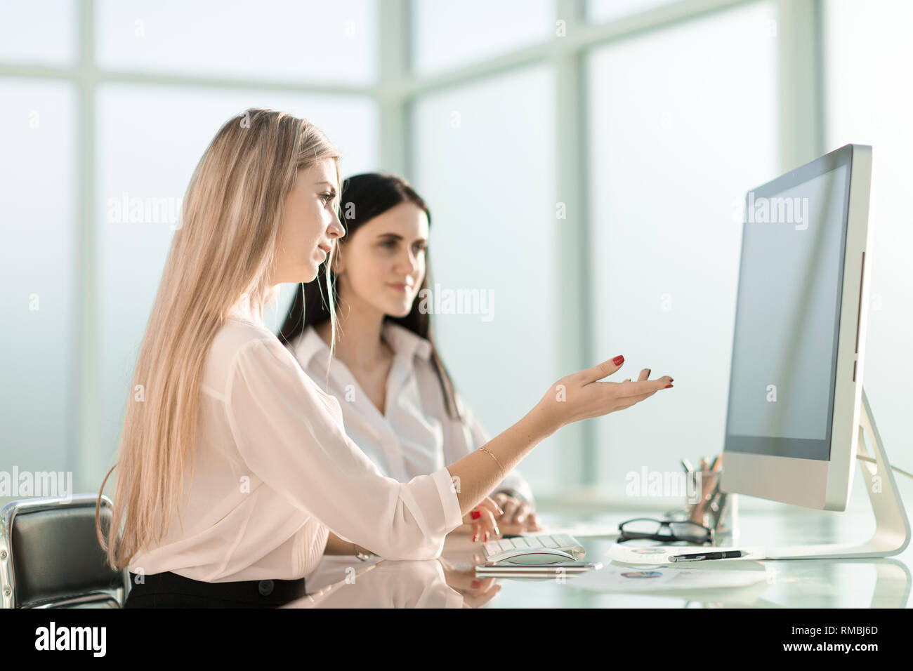 two employees sitting at the office Desk Stock Photo - Alamy