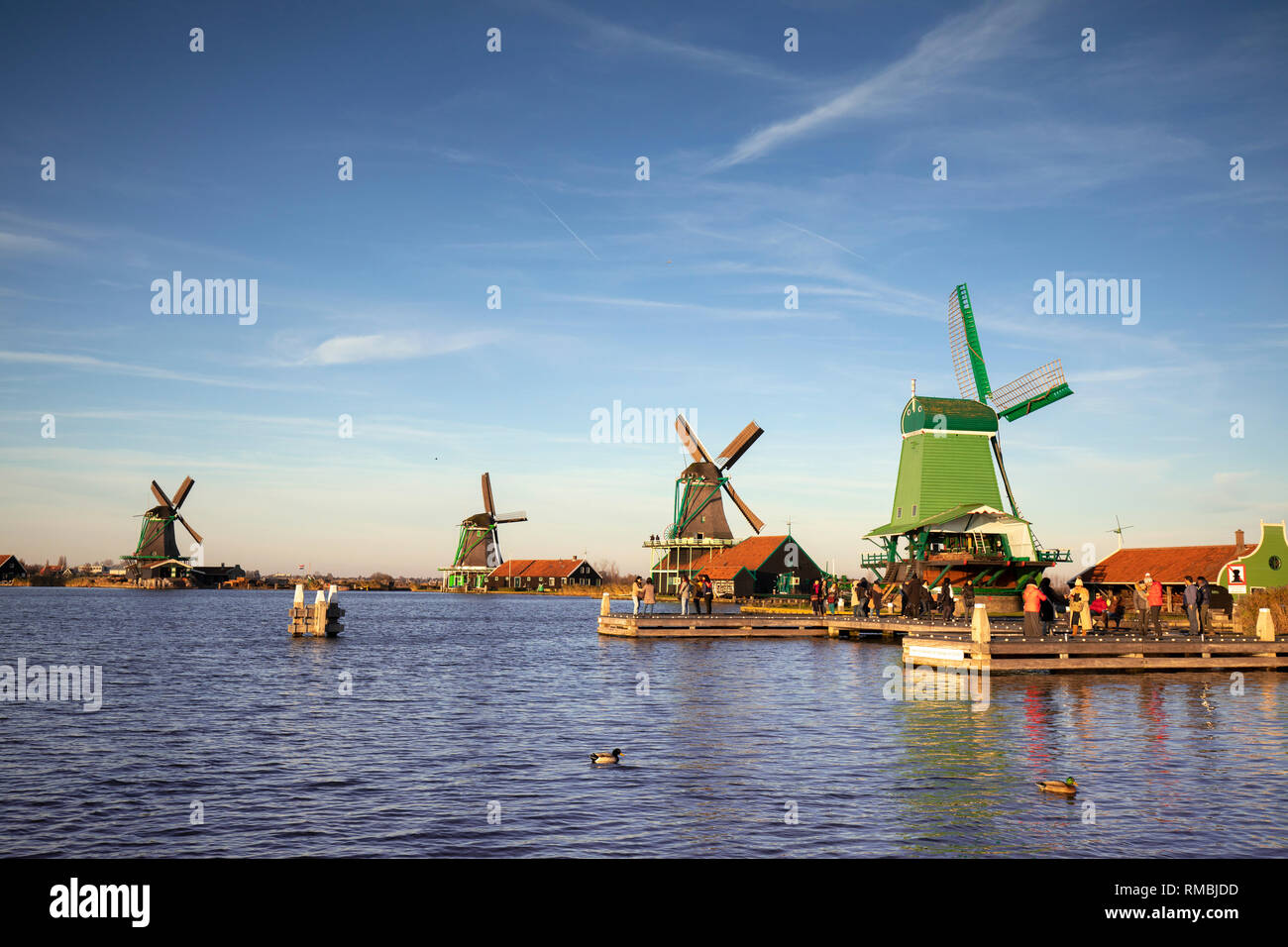Picturesque typical autumn Dutch windmill landscape with a row of a ...