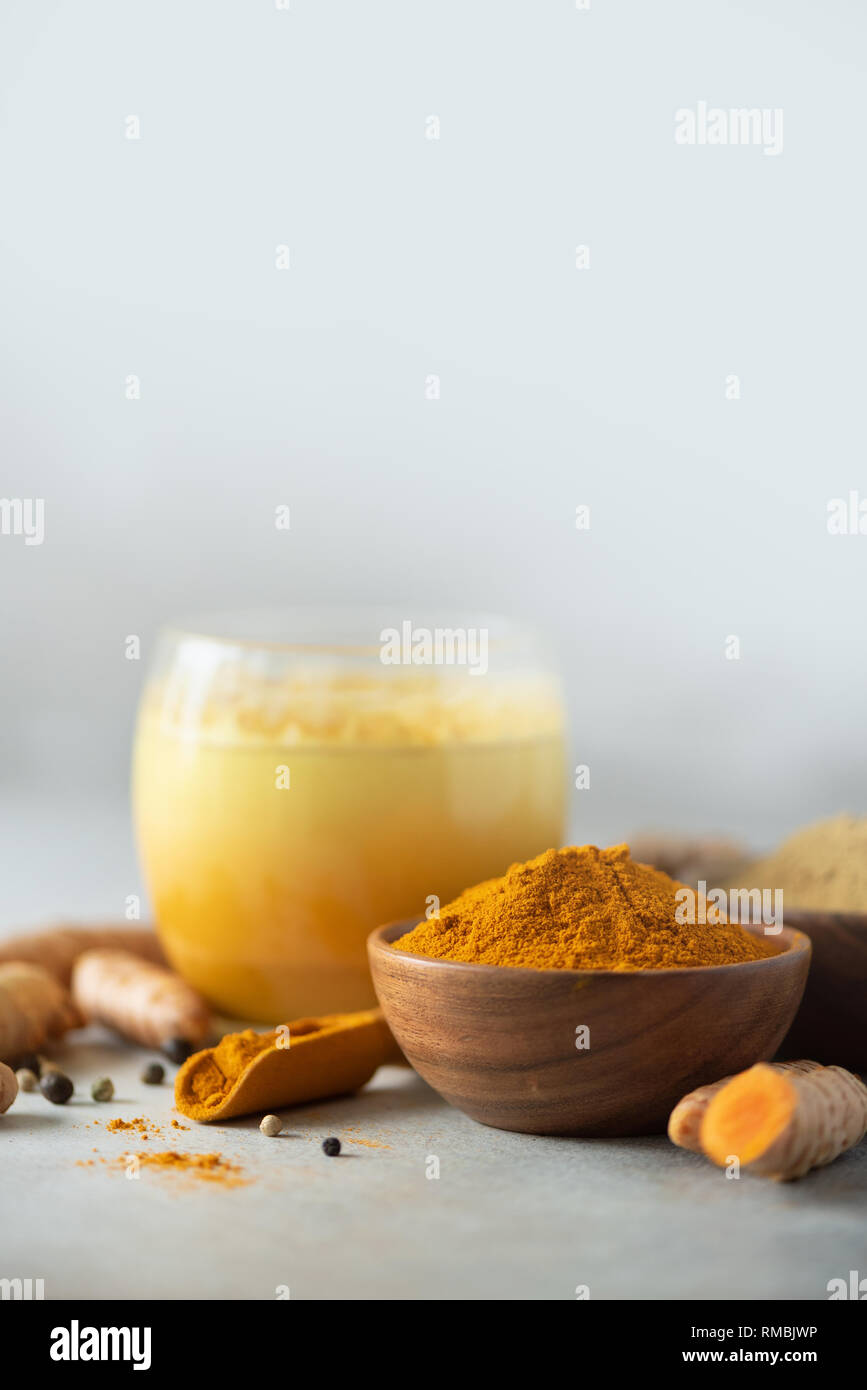 Yellow turmeric latte drink. Golden milk with cinnamon, turmeric ...