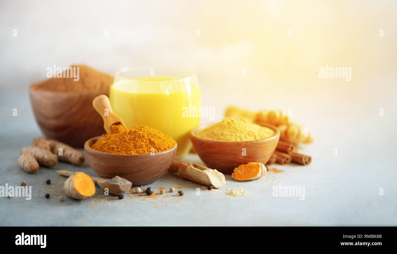 Yellow turmeric latte drink. Golden milk with cinnamon, turmeric ...