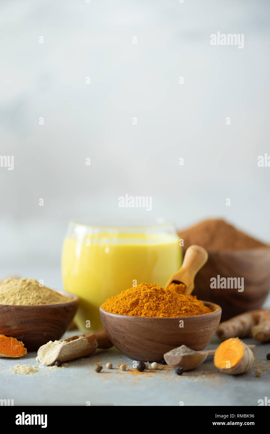 Yellow turmeric latte drink. Golden milk with cinnamon, turmeric ...