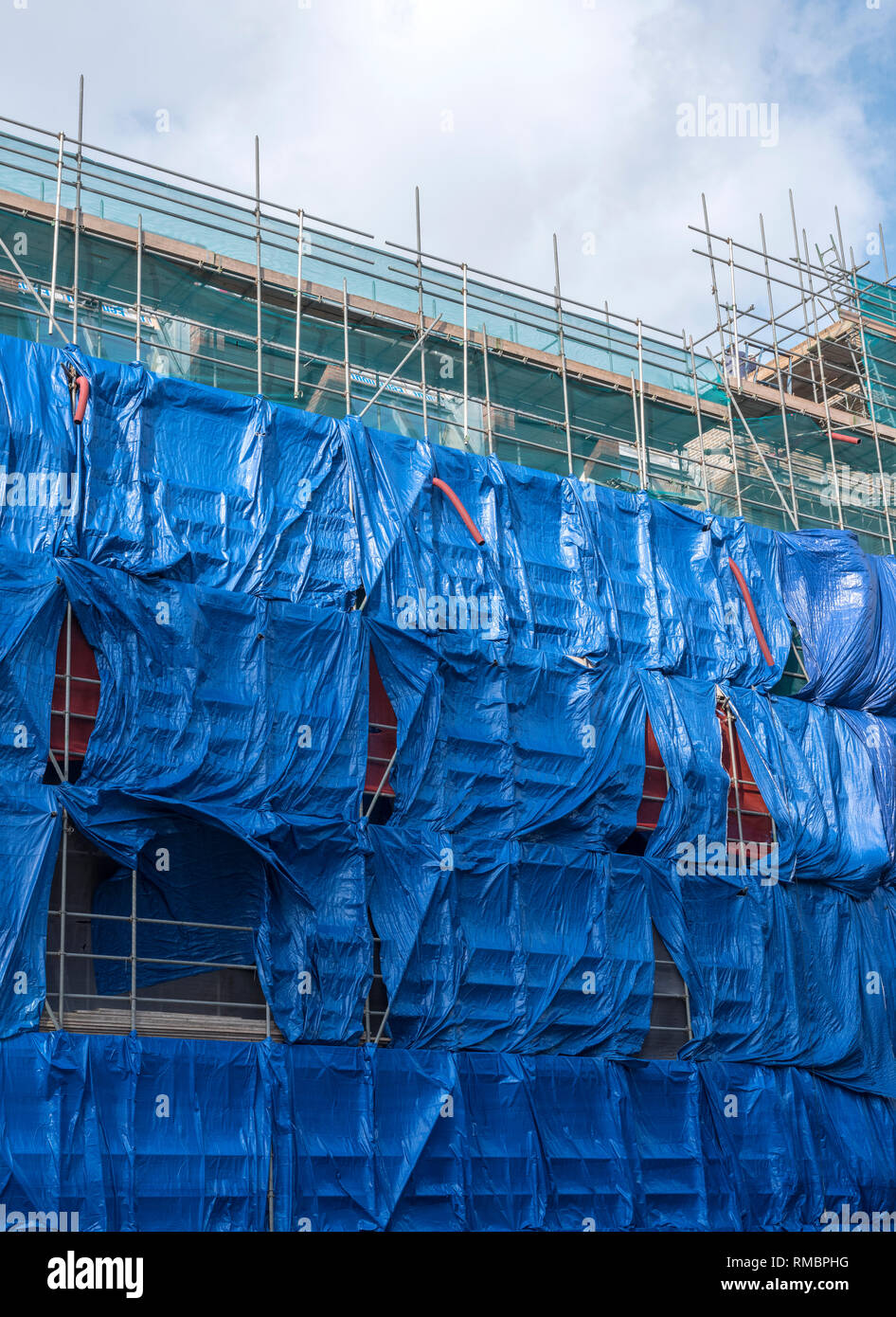 blue safety netting on scaffolding on building site in dutch town of ...