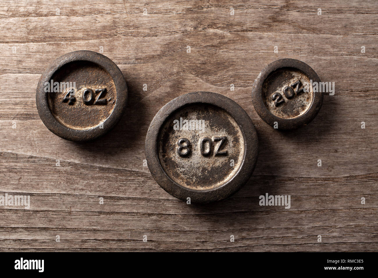 Old rusty scale weight on wooden table. Dirty, retro and rustic. Weight ...