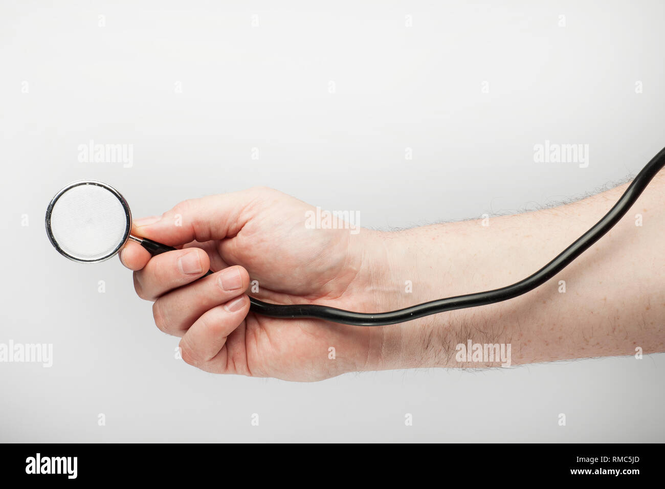 Male hand holding a stethoscope, isolated on the white background Stock ...