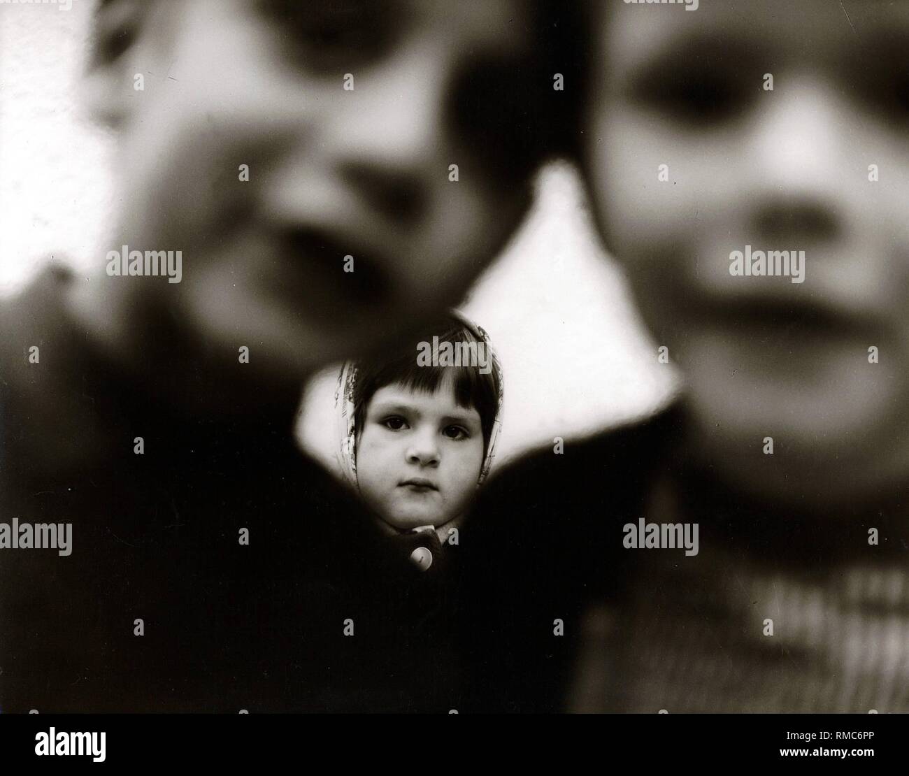 A girl is seen between two boy faces Stock Photo - Alamy