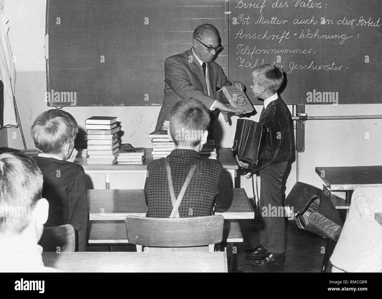 Handing books classroom Black and White Stock Photos & Images - Alamy