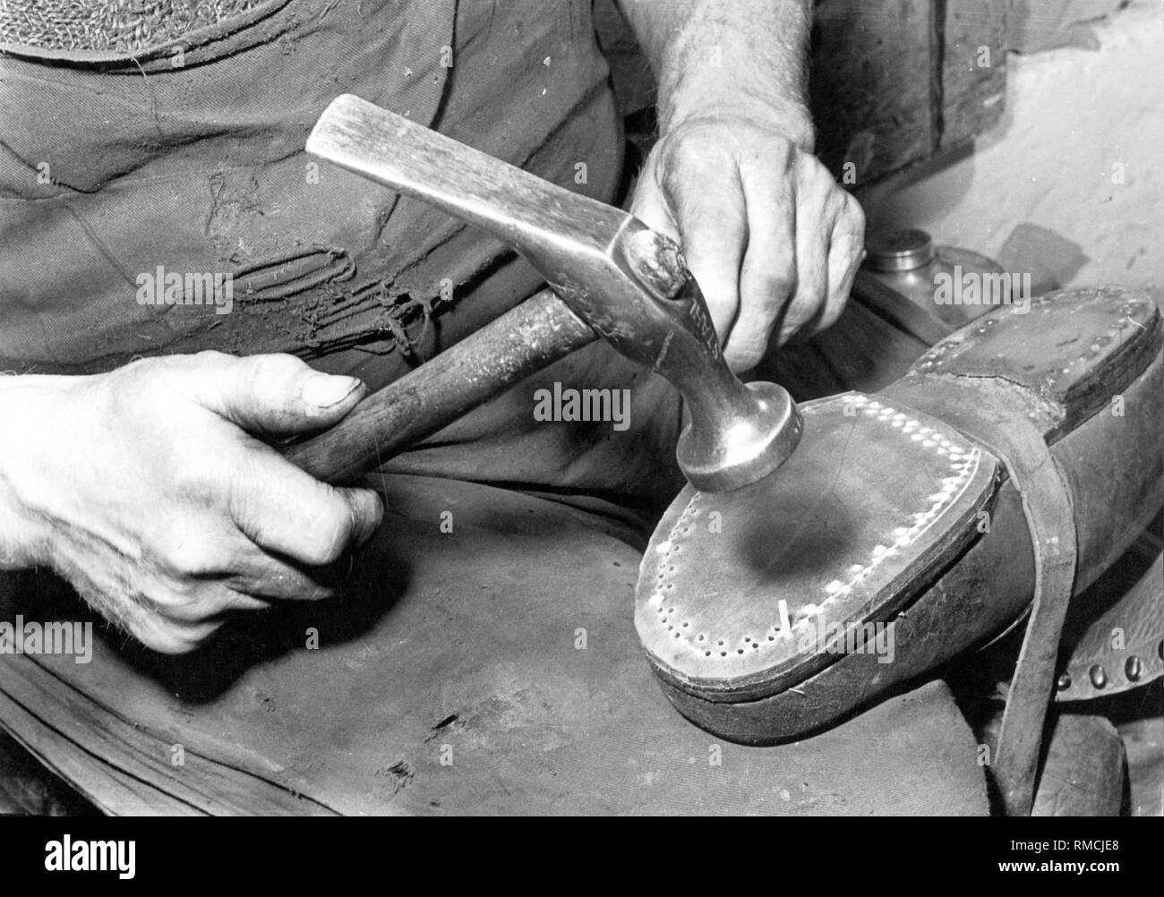 A shoemaker at work Stock Photo - Alamy