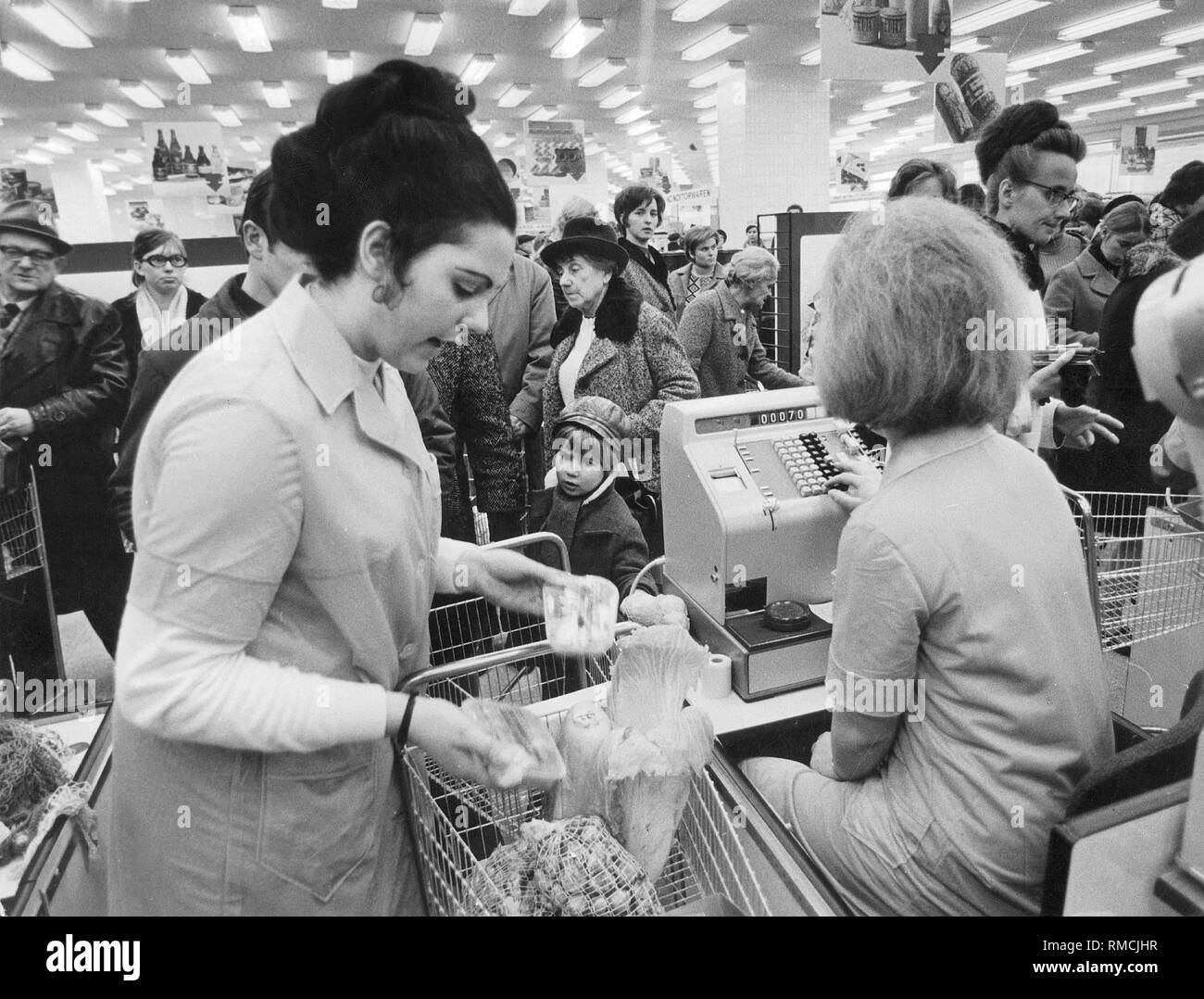 Customers at the cash register of the food department of the East ...