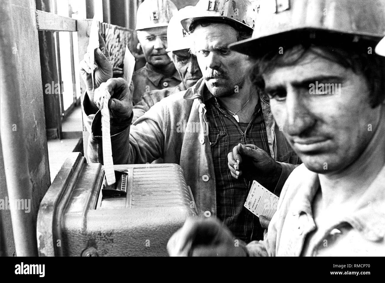 Mining worker of the coal mine "Ruhrkohle AG" at the time clock during ...