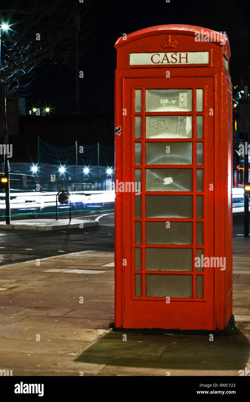 A classic Victorian red telephone box converted into a cash ATM machine ...