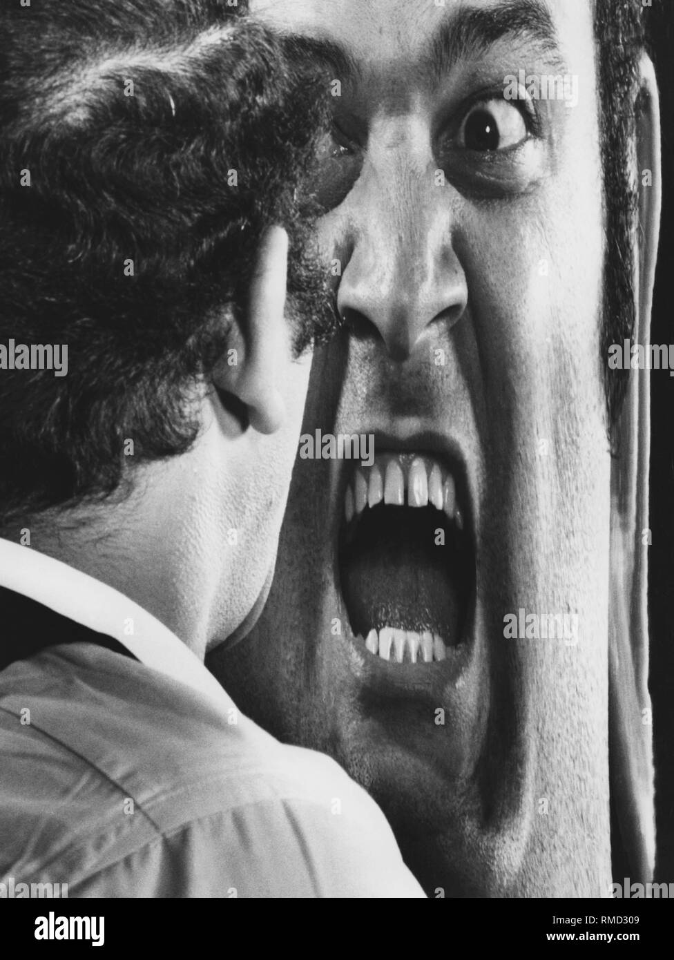 Roaring man in a distorting mirror, 60s Stock Photo - Alamy