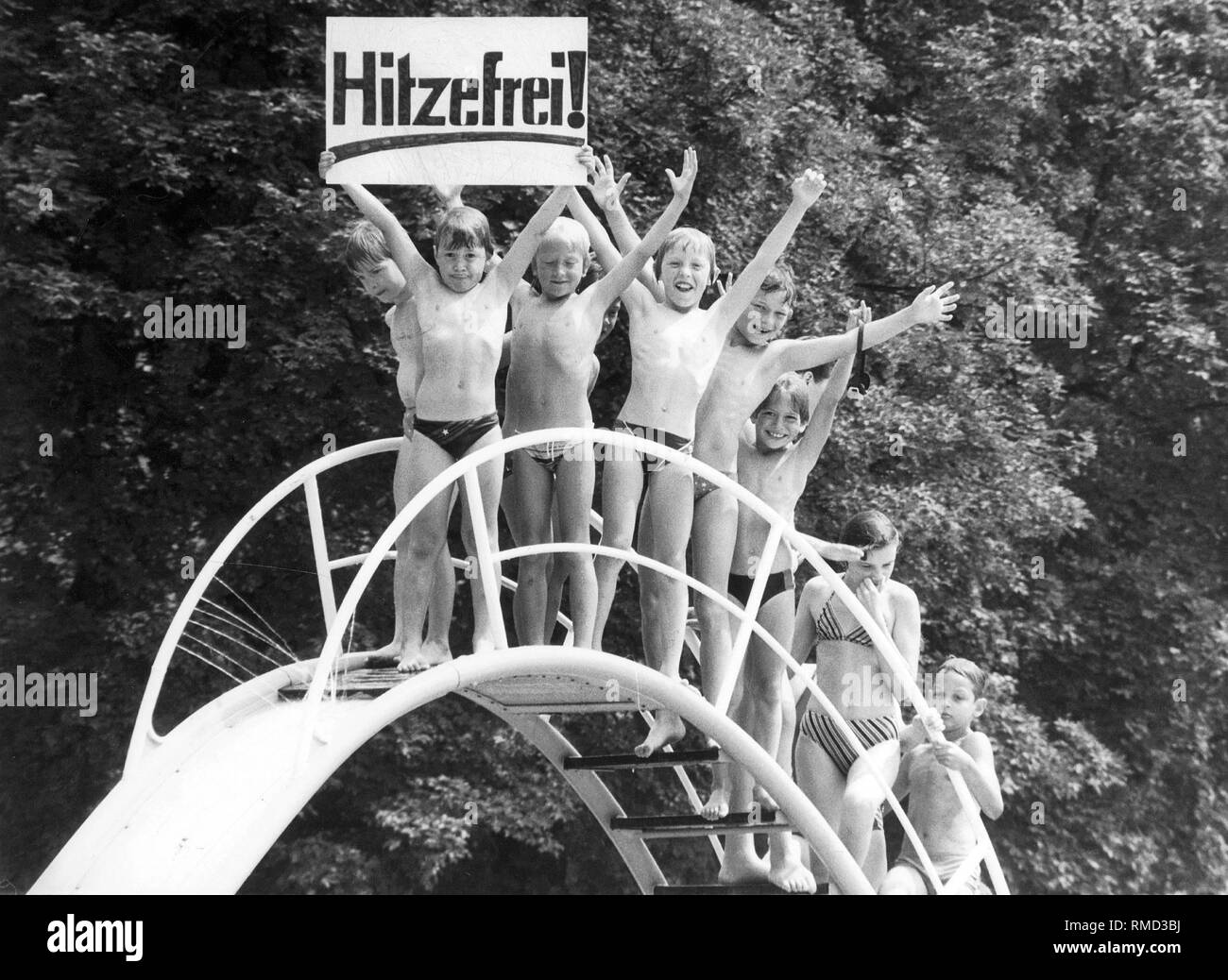 Students of a primary school in an outdoor pool enjoying their time off ...