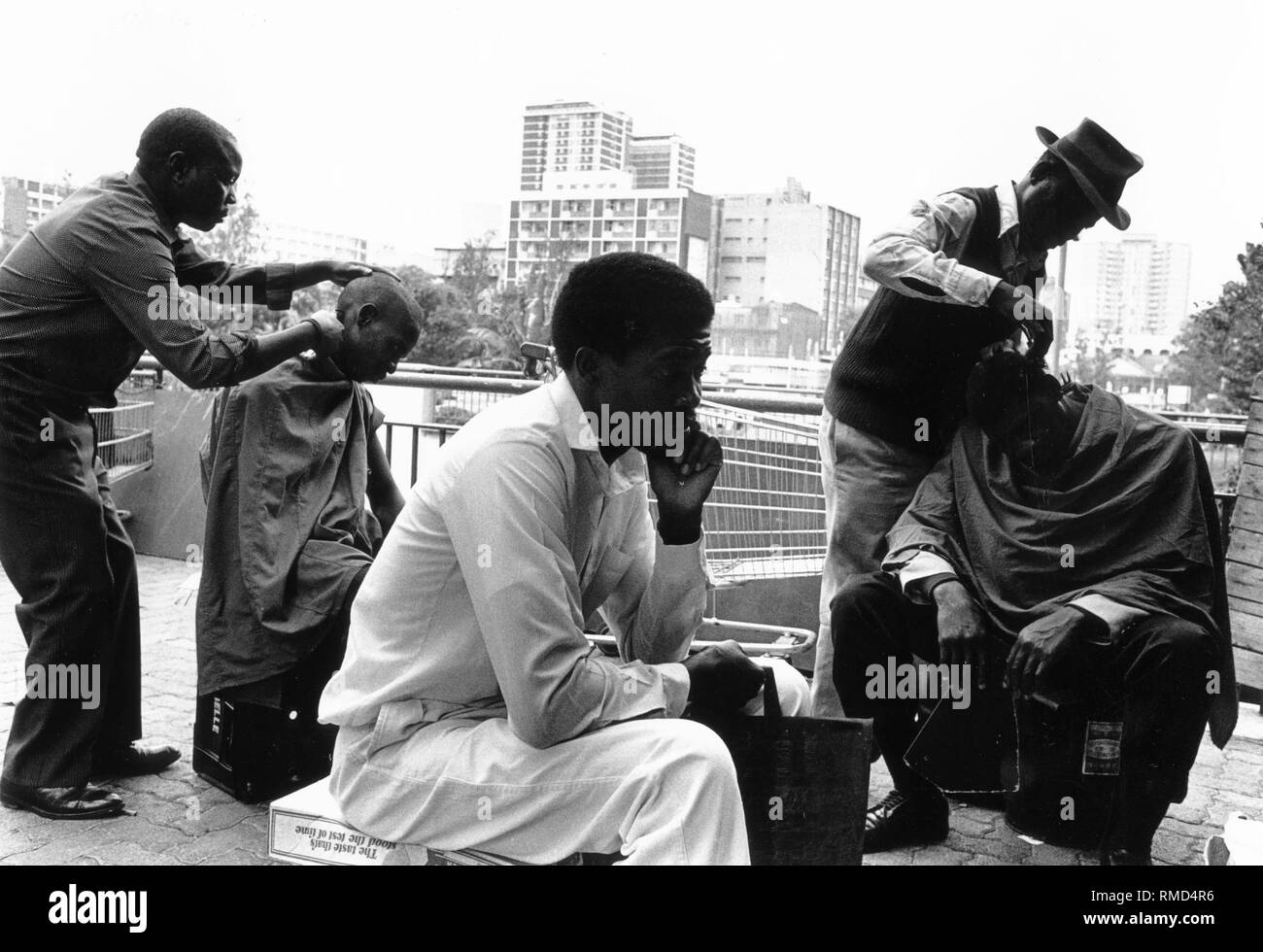 Barbers cut their customers' hair on a bridge in Johannesburg Stock ...