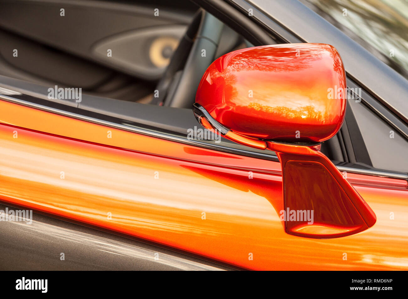 close-up of a driving mirror on a bright orange luxury sports car Stock ...