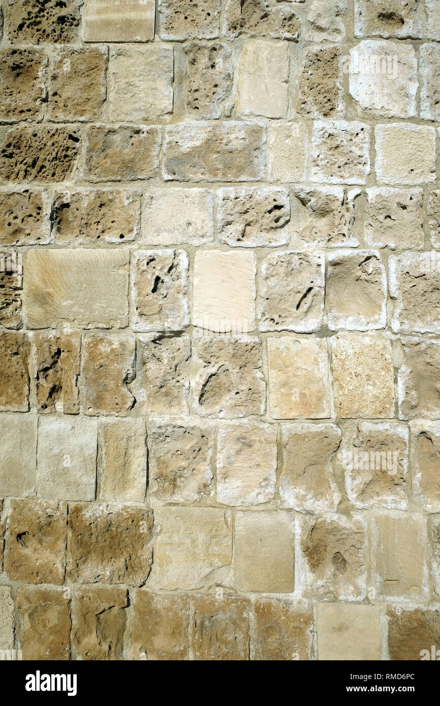 Vintage antique wall from old sandy limestone as background front view ...