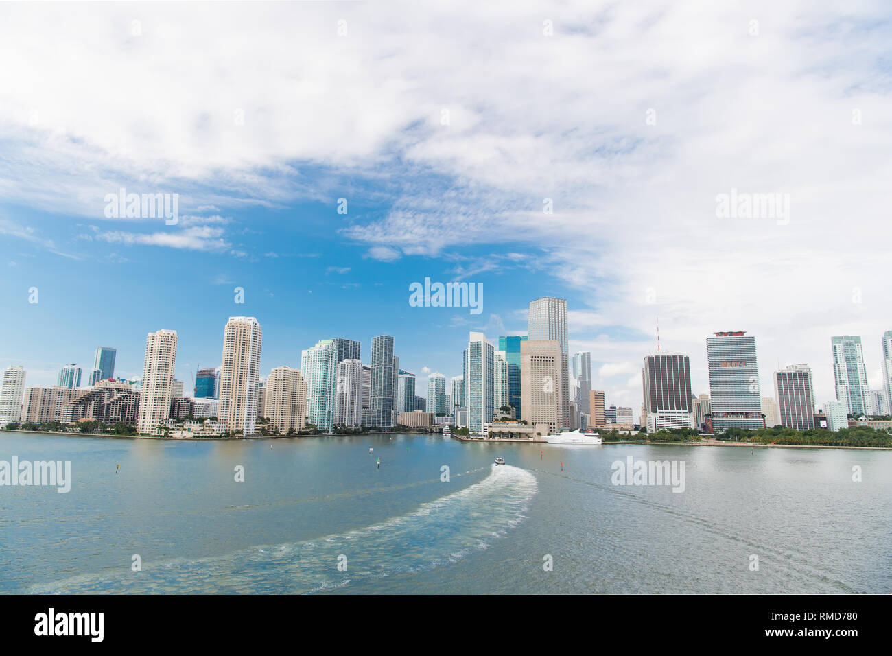 Aerial view of Miami skyscrapers with blue cloudy sky, white boat ...