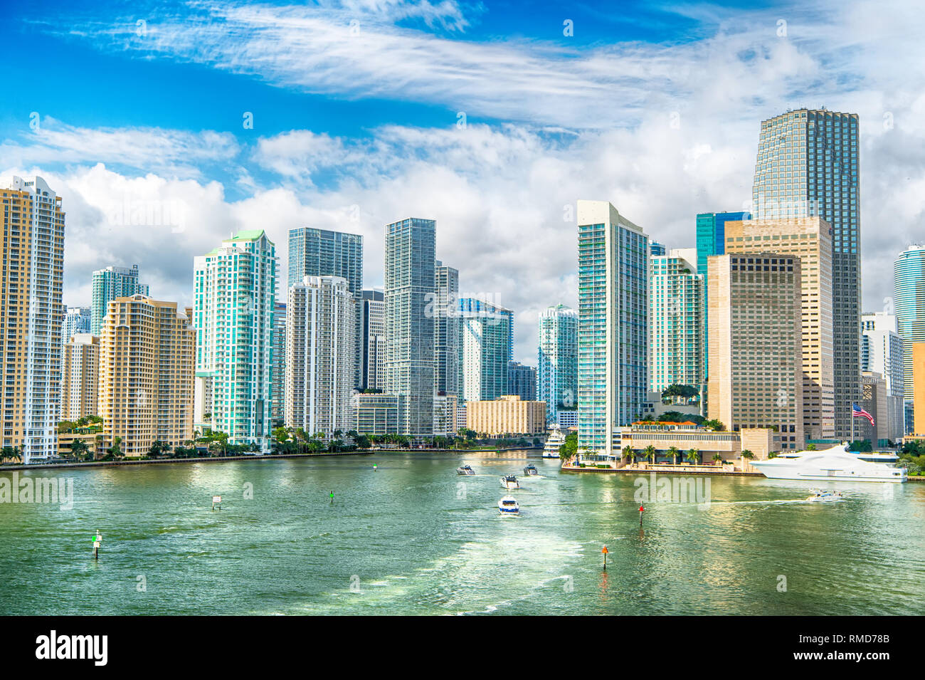 Aerial view of Miami skyscrapers with blue cloudy sky, white boat ...