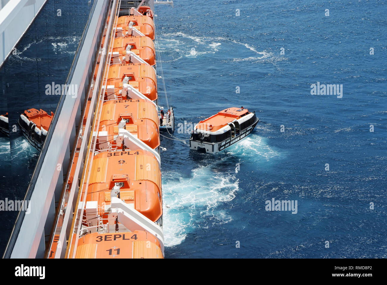 Dubronik, Croatia - December, 20, 2007: Orange lifeboats, modern boats ...