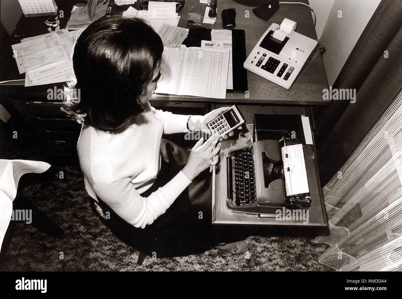 Young secretary in the everyday office life, 1975 Stock Photo - Alamy