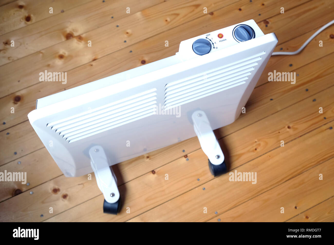 Working white electric convector heater with control panel on top on ...