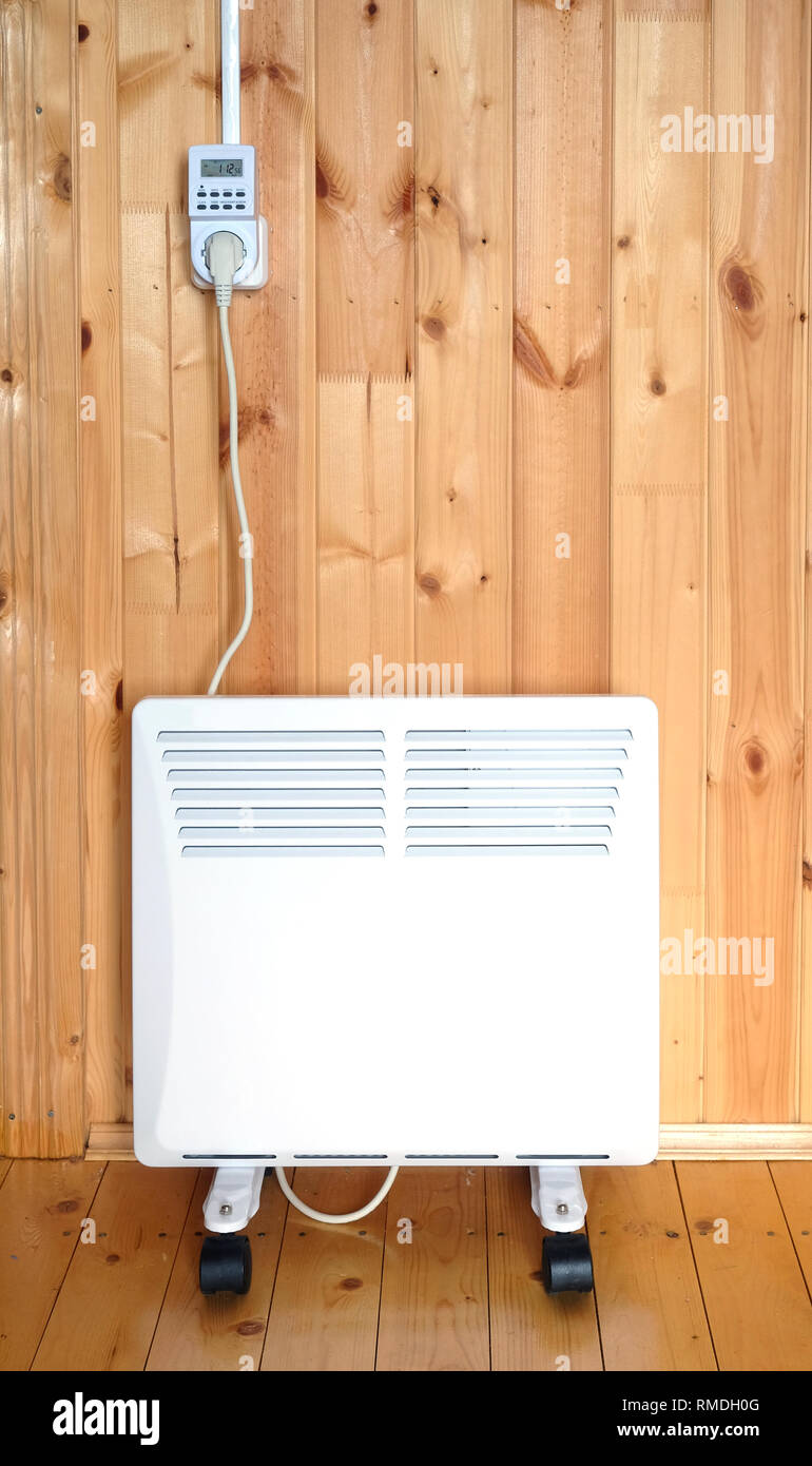 Working white electric convector heater plugged to timer power smart ...