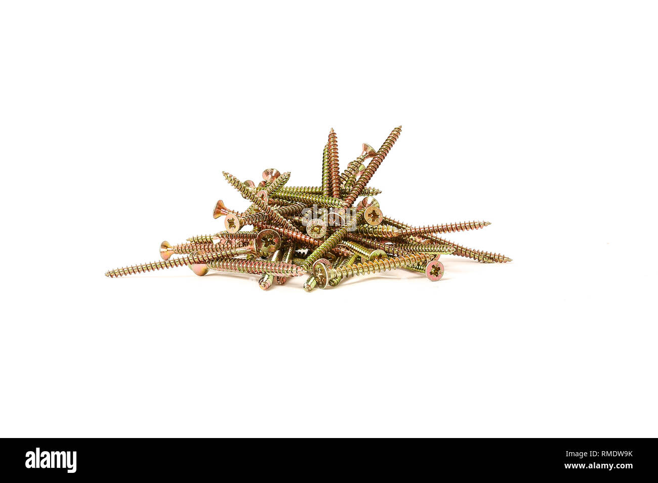 Pile of screws on a wood background Cut Out Stock Images & Pictures - Alamy