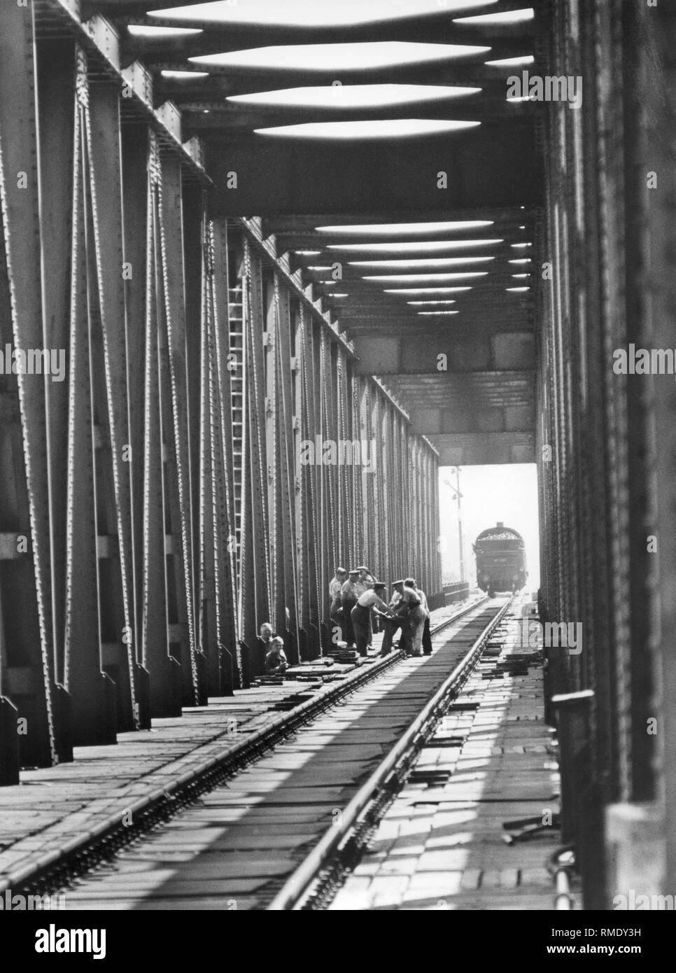 Track work in a steel bridge, 1950s Stock Photo - Alamy