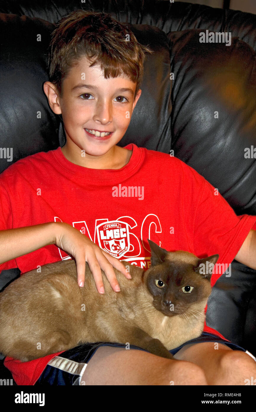 young boy; holding cat, smiling; front teeth gap; handsome; cute ...