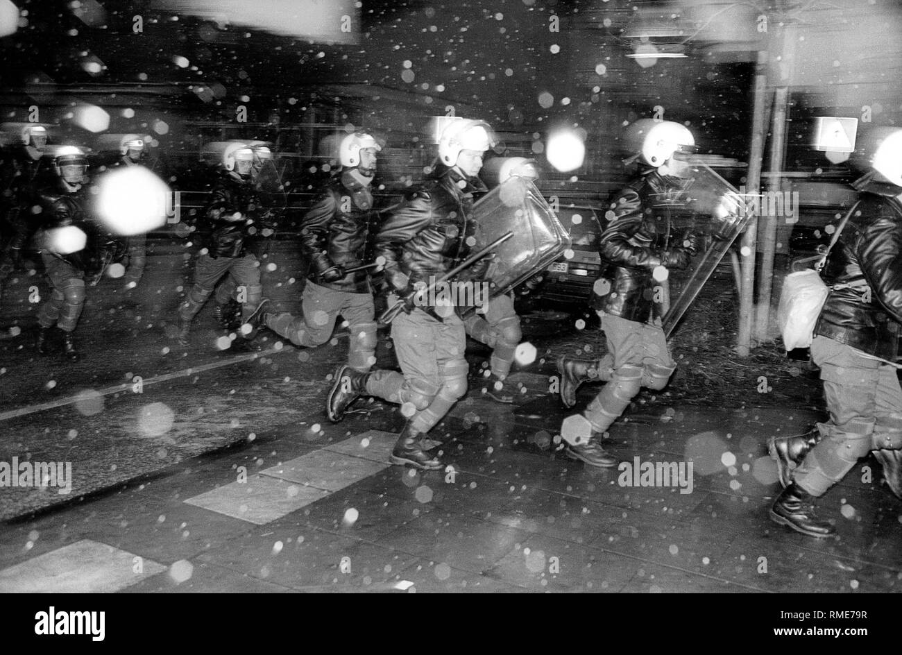 A group of officers of the riot police, equipped with helmets ...