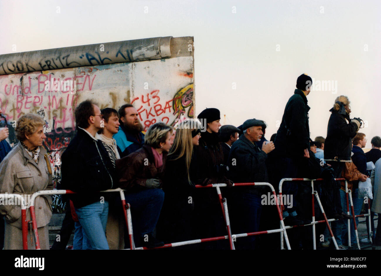 Shortly after the fall of the Wall, citizens of Berlin are standing at ...