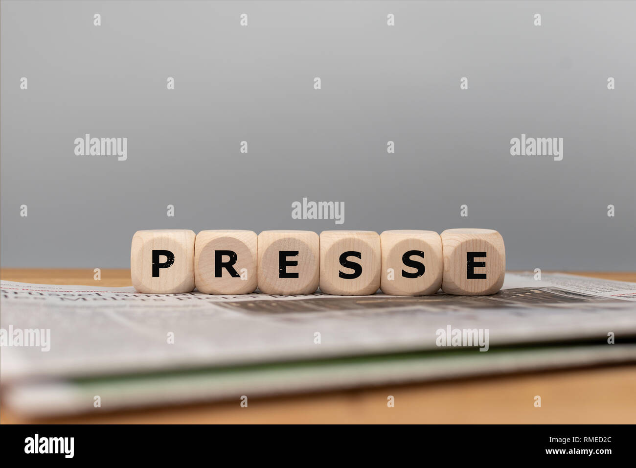 Dice form the German word "PRESSE" ("PRESS" in English") on a newspaper ...