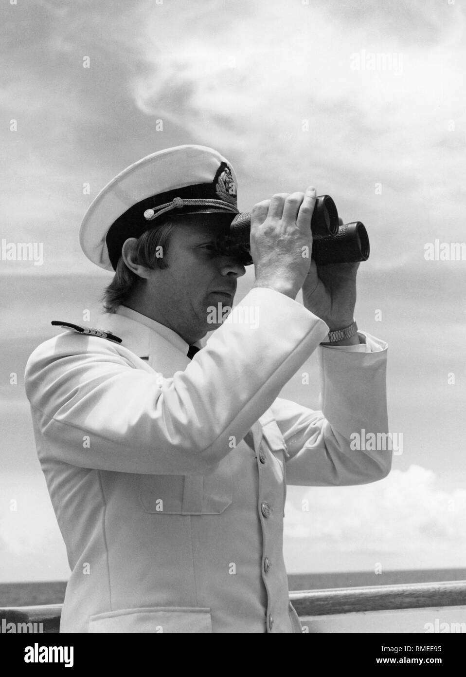 A captain monitors the sea with binoculars Stock Photo - Alamy