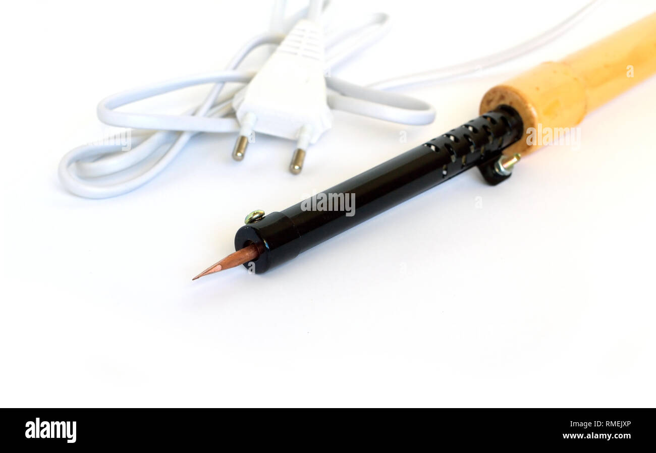 Electric soldering iron with a wooden handle and a white wire with a ...