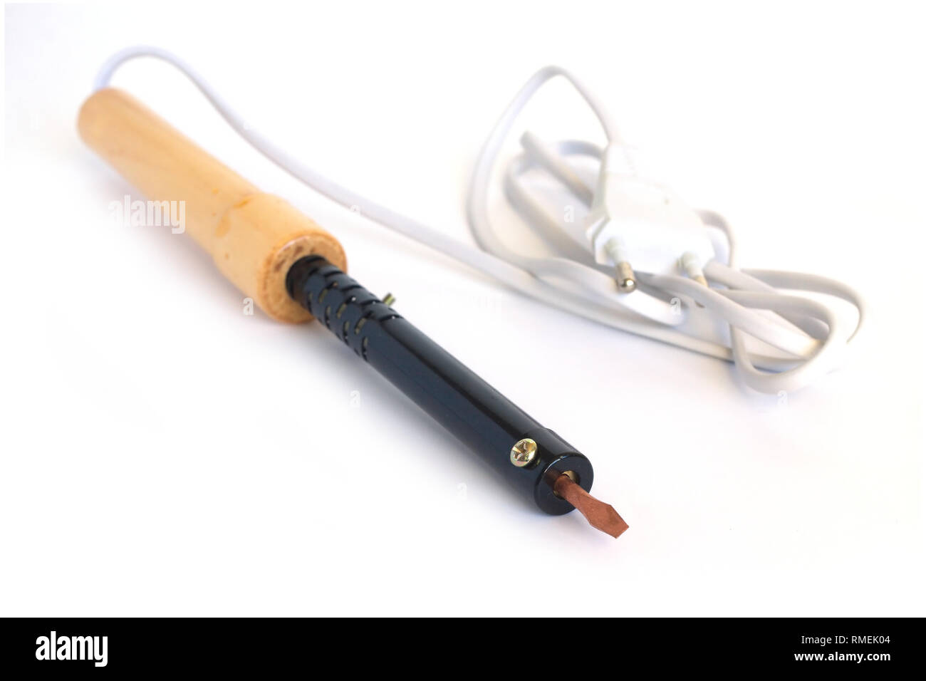 Electric soldering iron with a wooden handle and a white wire with a ...