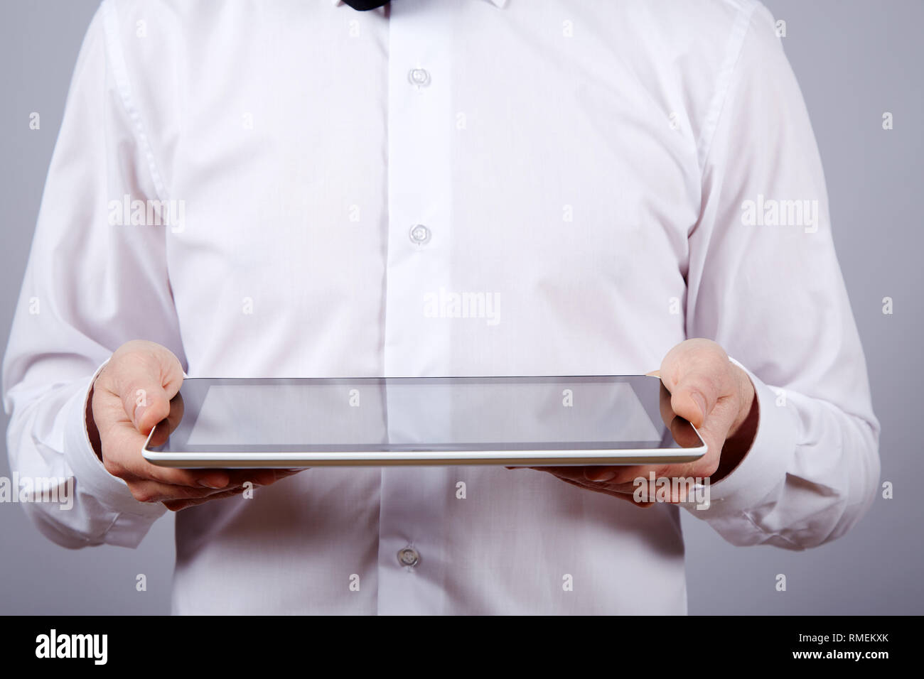 Worker at grey studio background Stock Photo - Alamy
