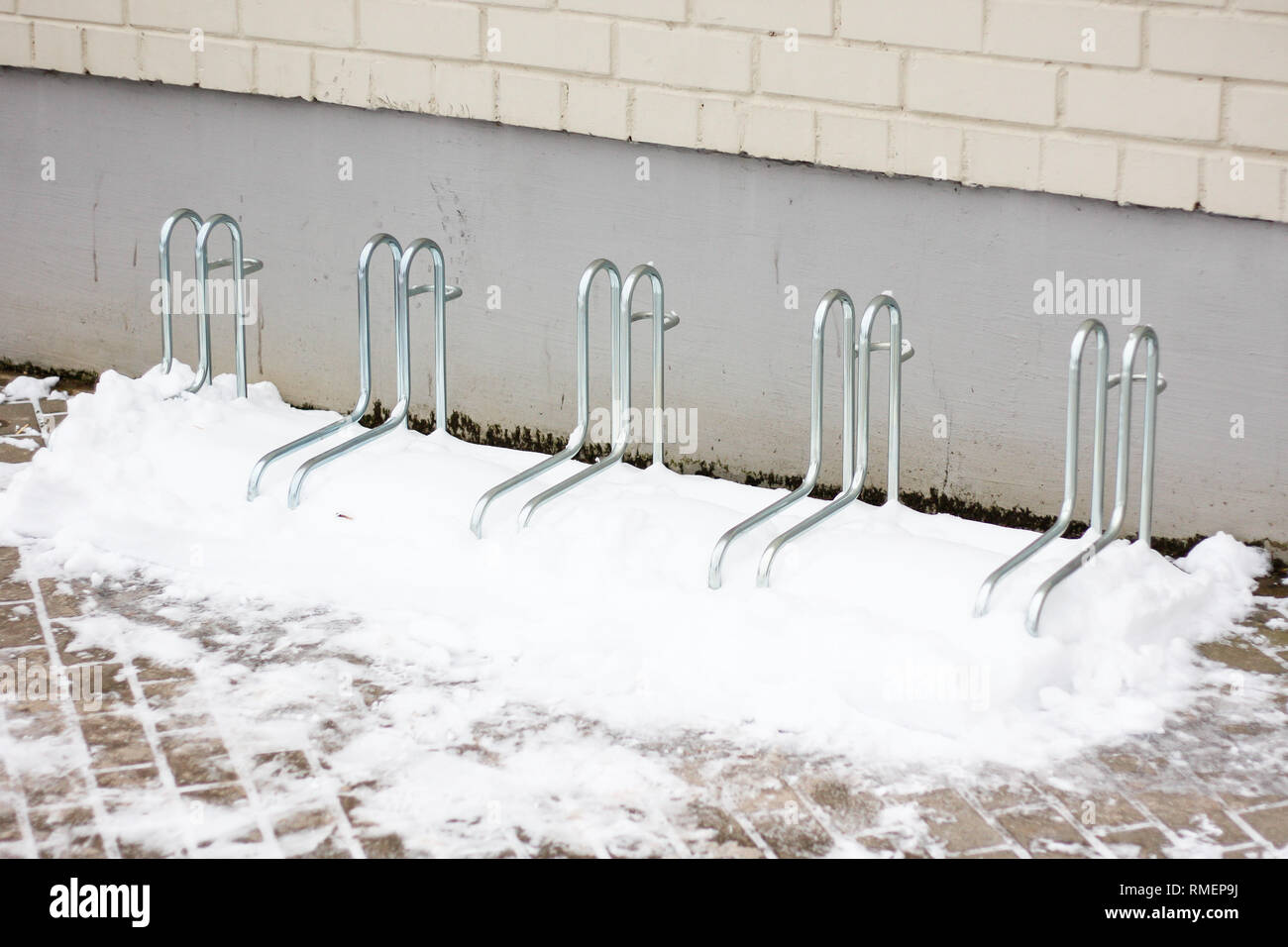 Winter view with snow fallen on a bicycle rack Stock Photo - Alamy