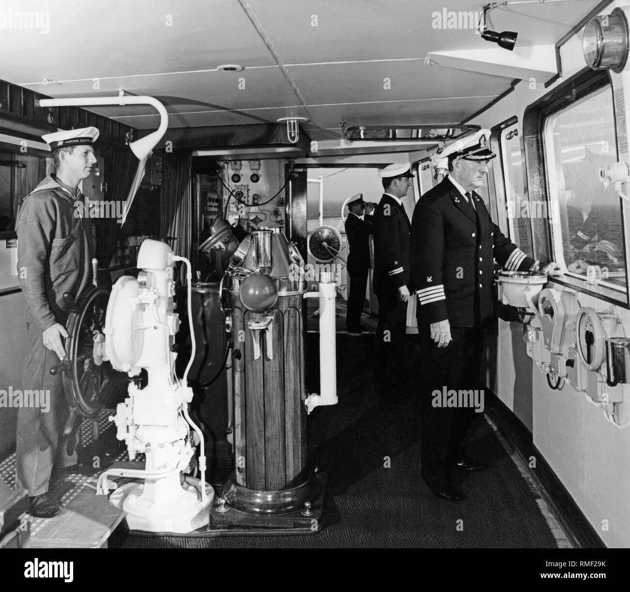 Captain Hans-Peter Klotzbach and parts of his crew on the bridge of the ...