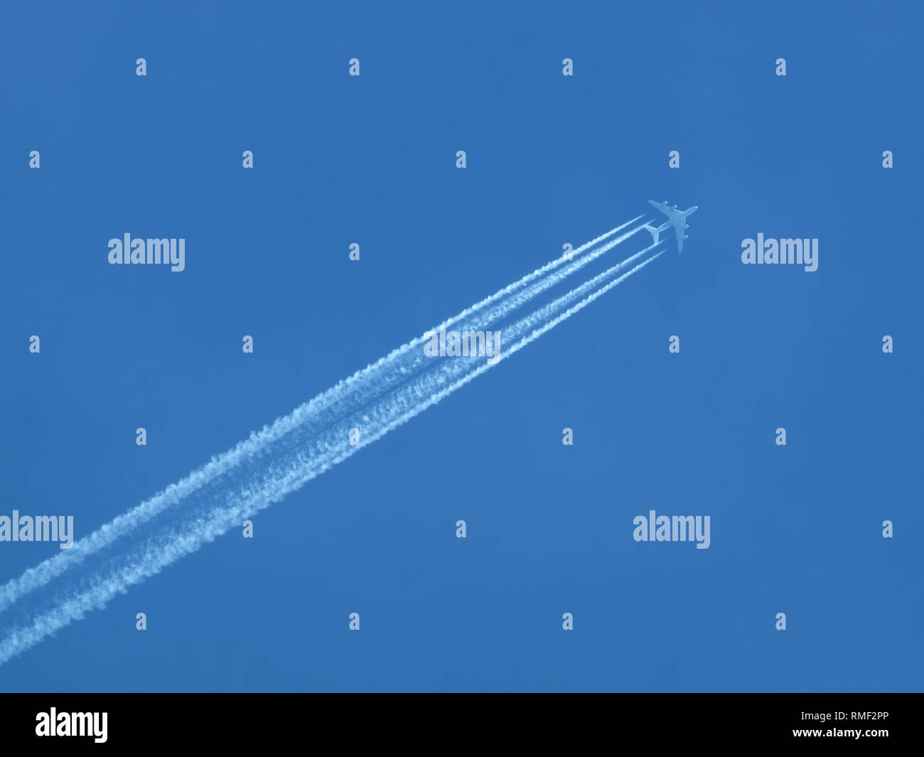 Big with four jet engines passenger supersonic plane flying high in ...