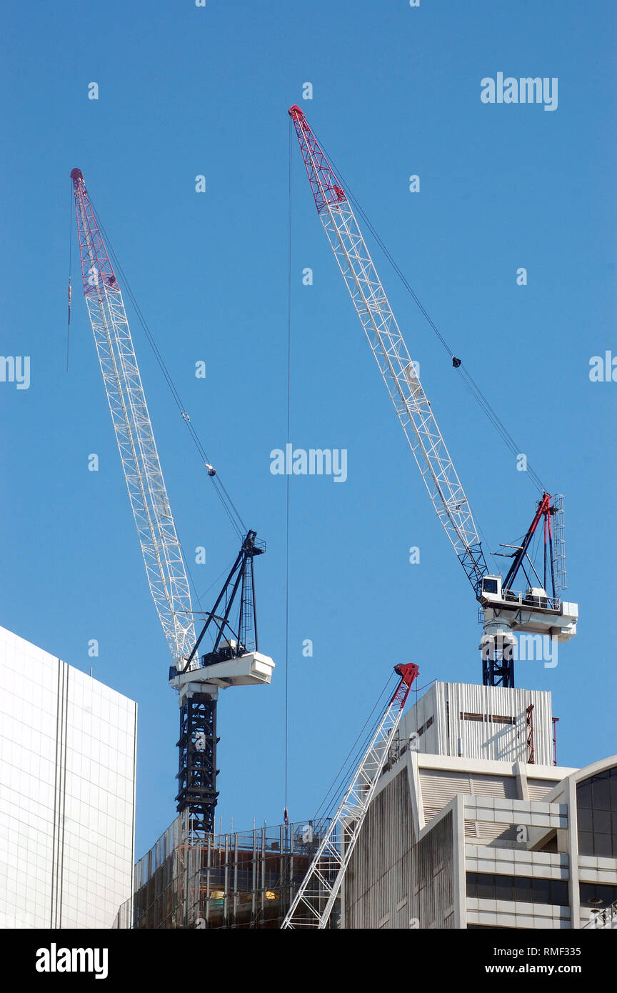 cranes at work in a central city buiding site Stock Photo - Alamy