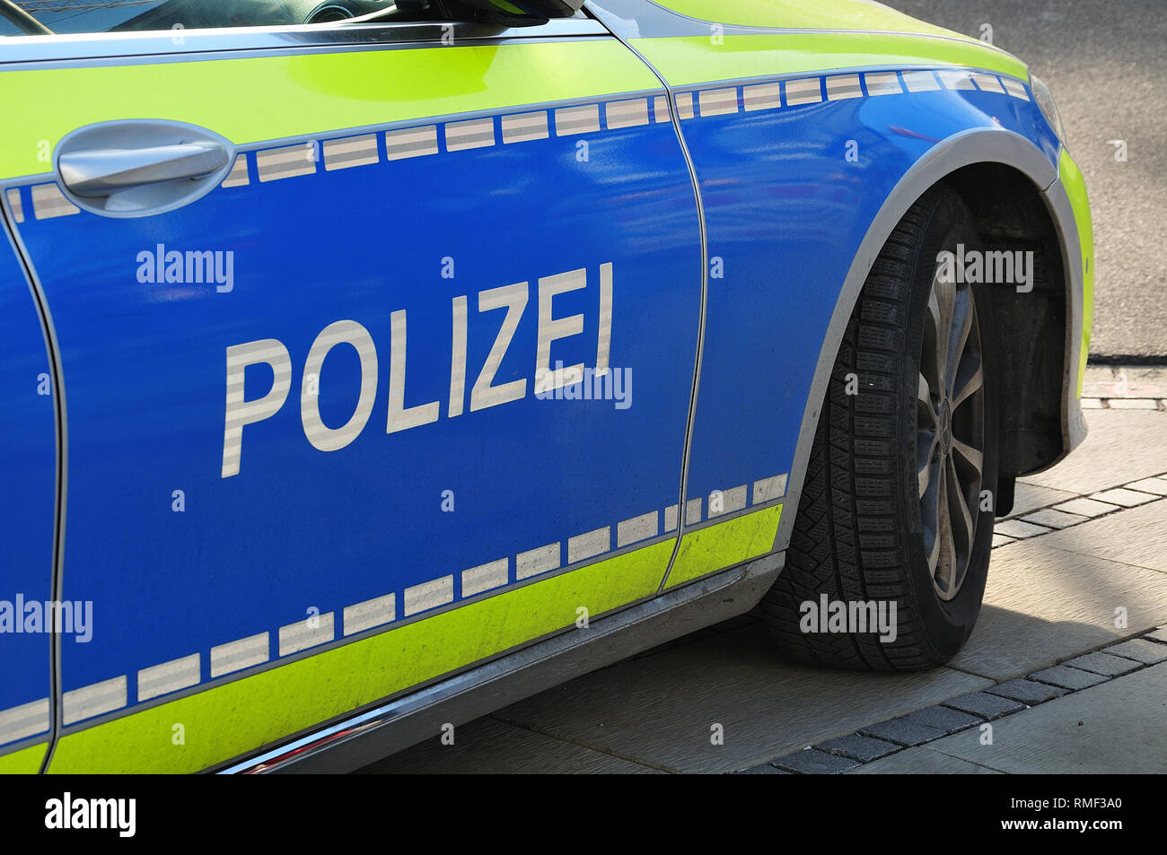side view of german police car with blue and yellow varnishing on ...