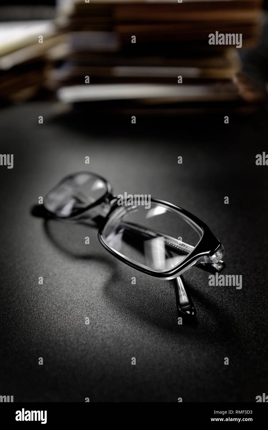 Glasses on desk with files and folders for business education work ...