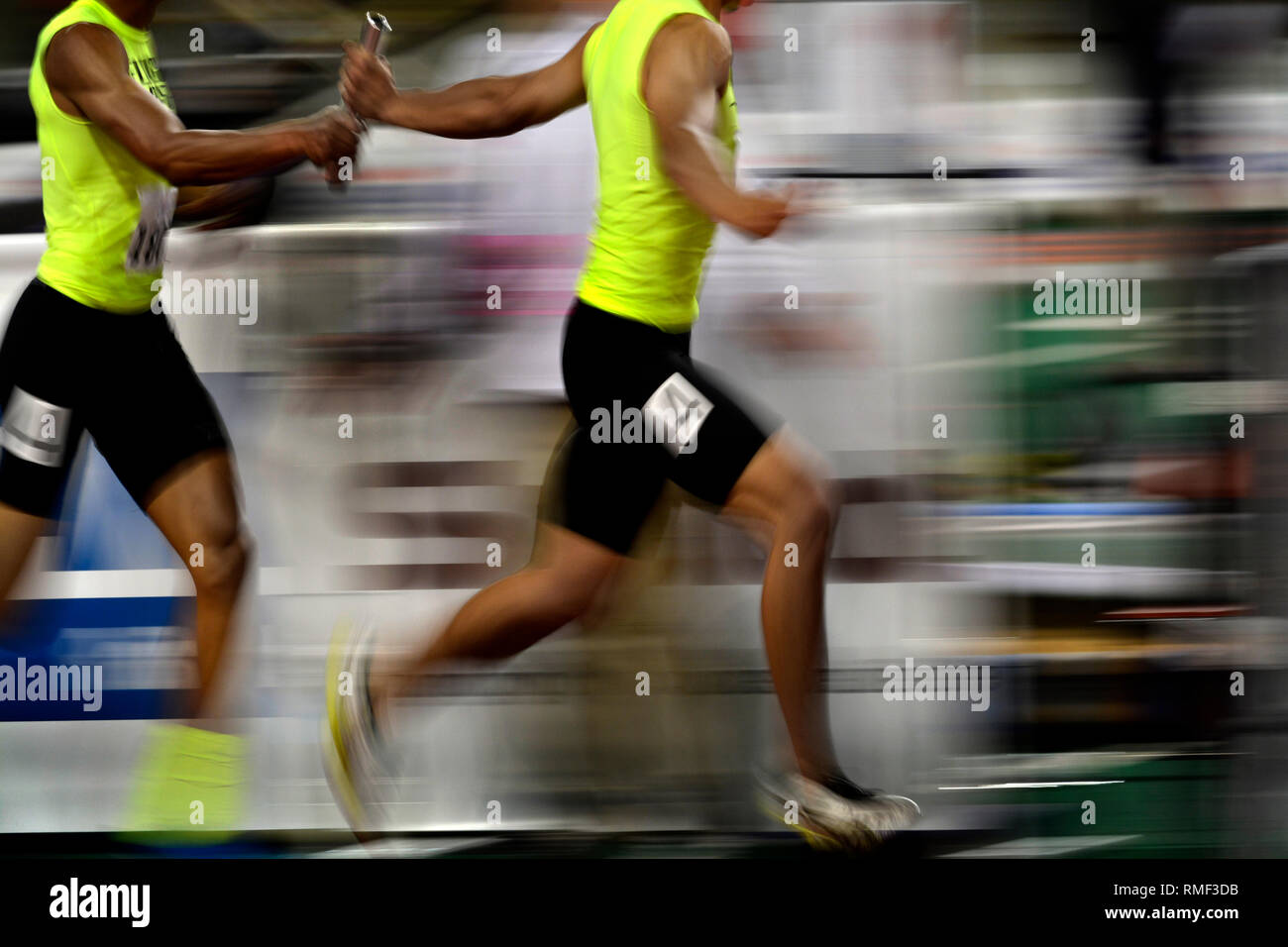 Relay race at meet running as a team towards vitory and success with ...