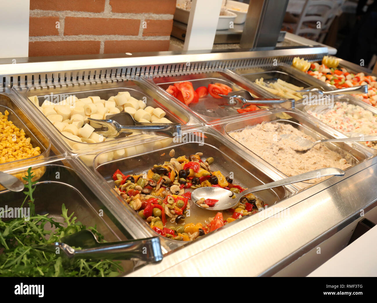 Inside a self service restaurant with many raw and cooked foods Stock ...