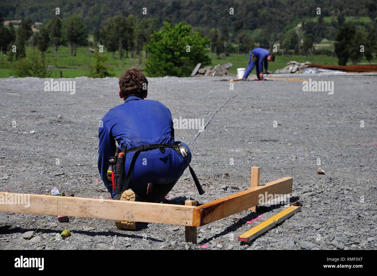 Builders mark out the profile for a building at a construction site ...
