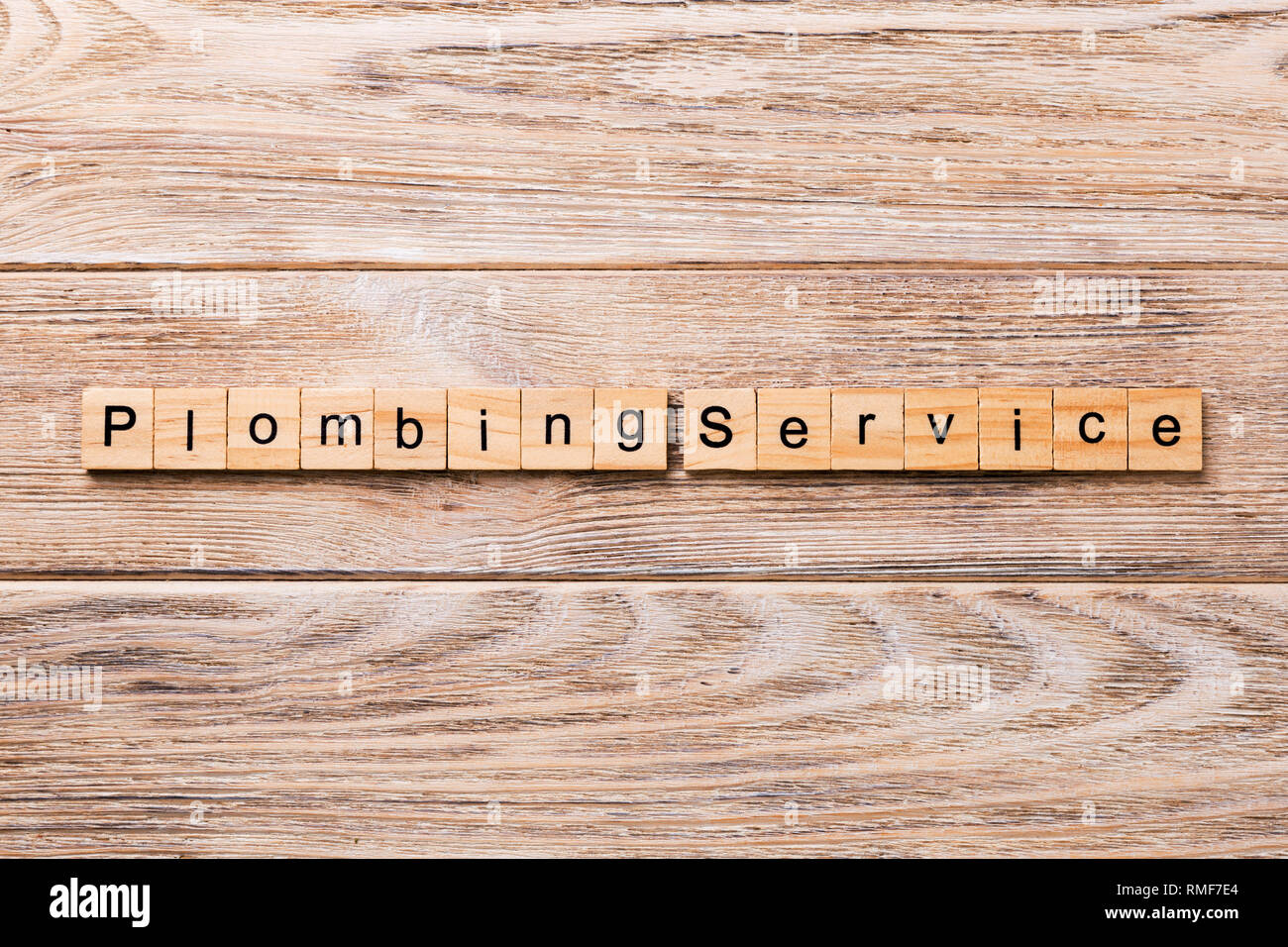 Plumbing service word written on wood block. Plumbing service text on ...