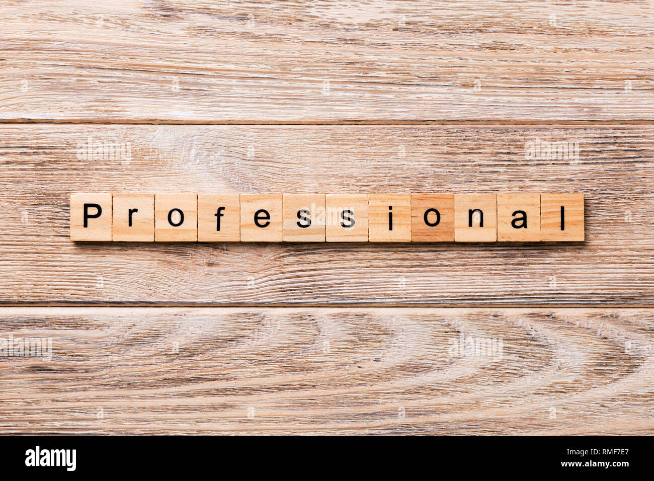 Professional word written on wood block. Professional text on wooden ...